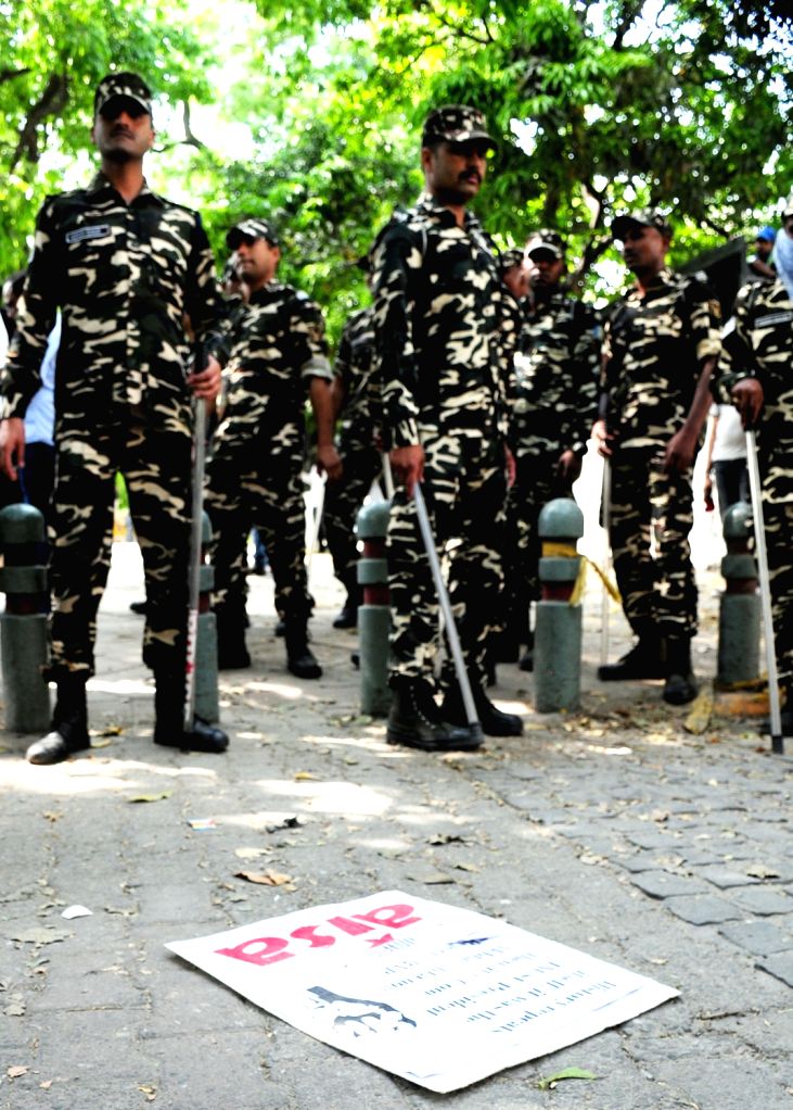 Security personnel stand guard during a protest by AISA