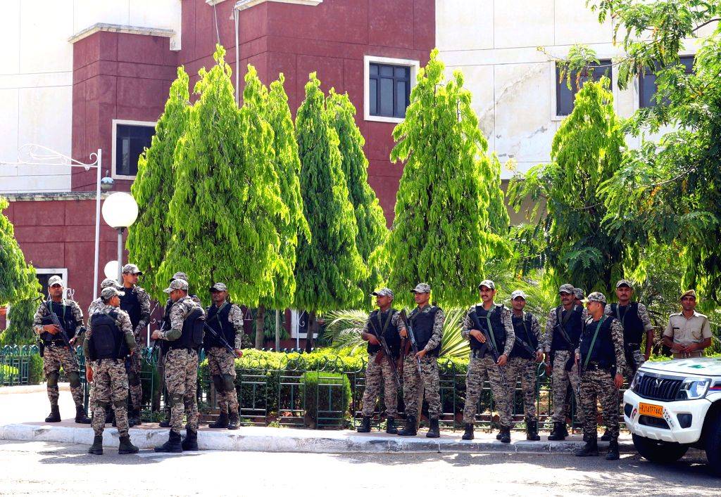 Security personnel stand guard outside a school