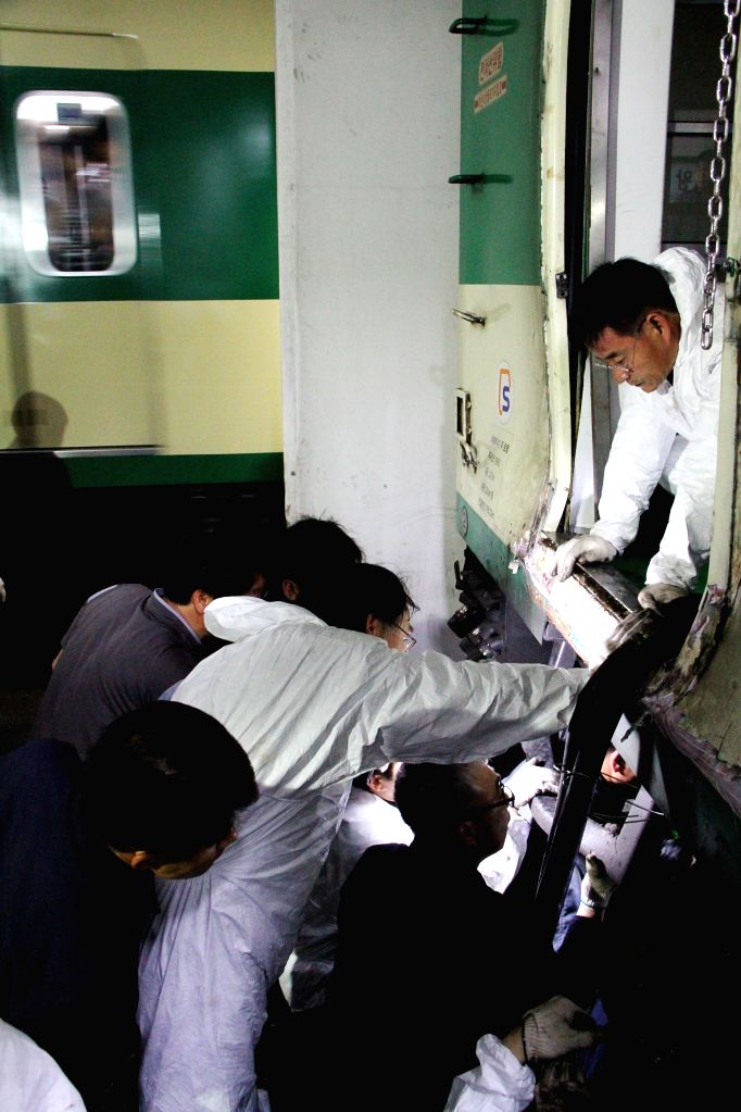 Mechanics work to restore the subway operation at Sangwangsimni Station ...