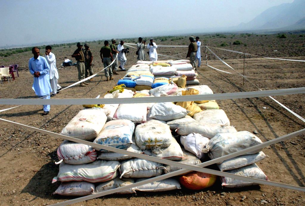 Sacks of seized hashish are displayed in Shakas area of northwest Pakistan