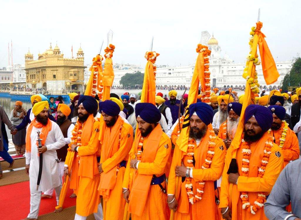 Sikh devotees carry the Guru Granth Sahib (Sikh holy book) during the ...