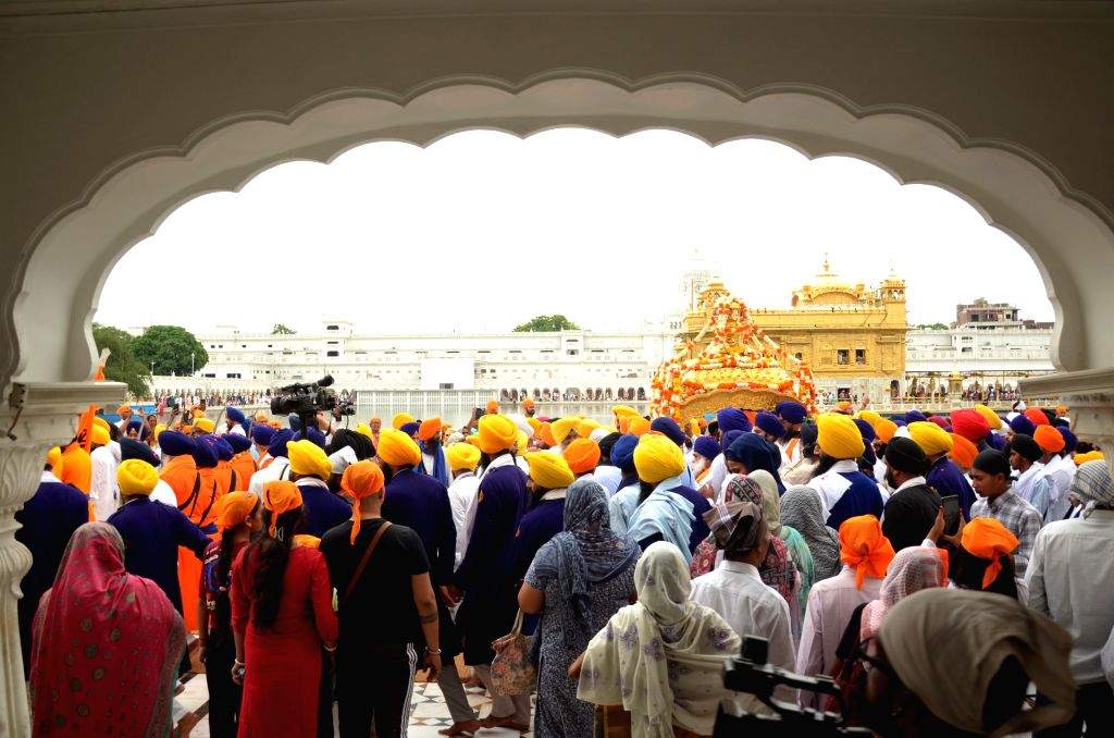 Sikh devotees carry the Guru Granth Sahib (Sikh holy book) during a ...