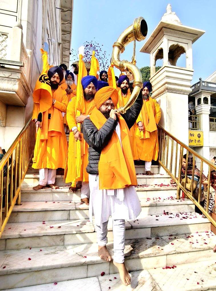 Sikh devotees carry the Guru Granth Sahib (Sikh holy book) during a ...