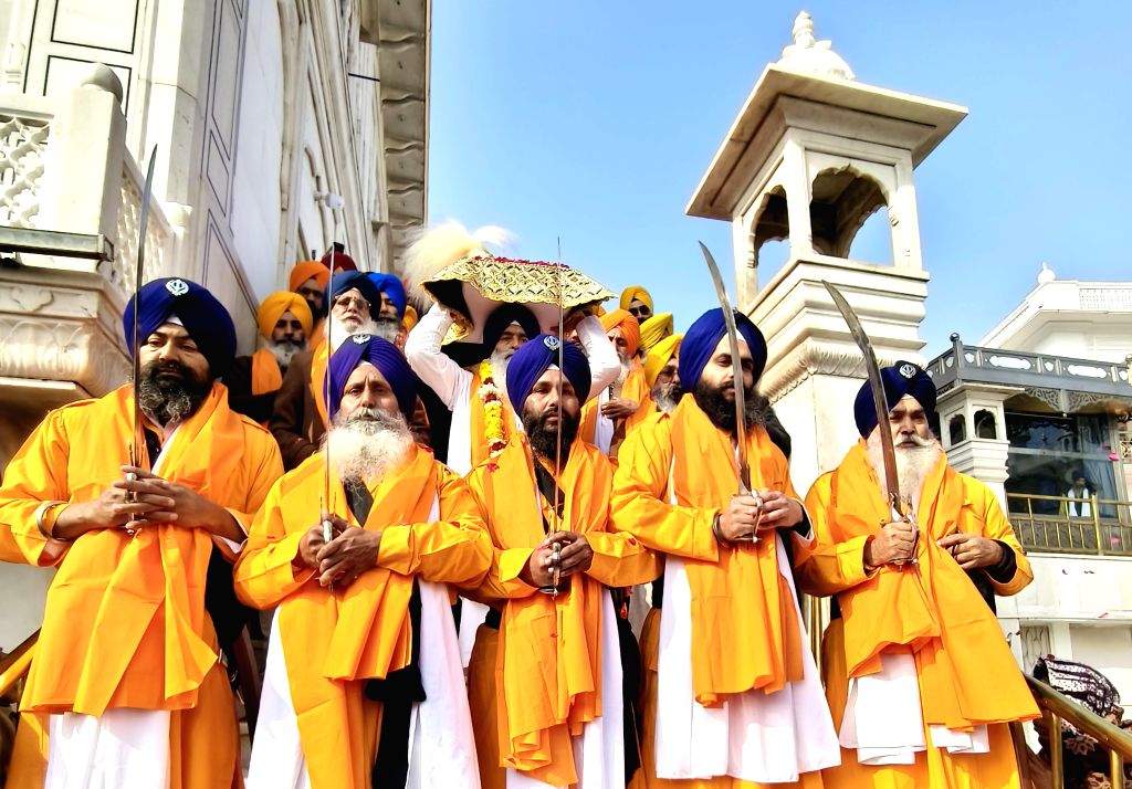 Sikh devotees carry the Guru Granth Sahib (Sikh holy book) during a ...