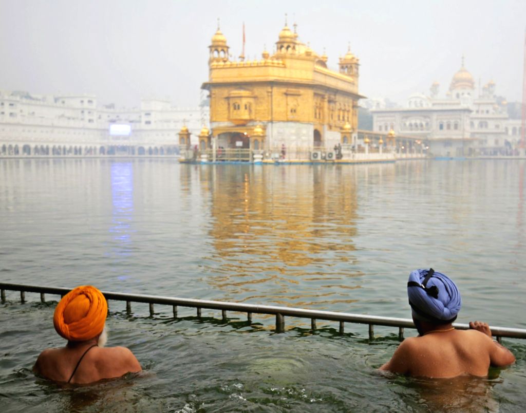 Sikh devotees take a holy dip in 'Sarovar