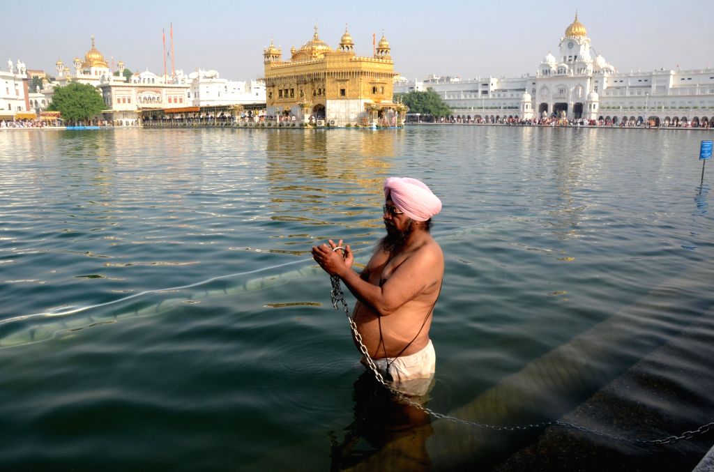 : Amritsar:Sikh Devotees take Holy dip in a sarovar of Harmandir Sahib ...