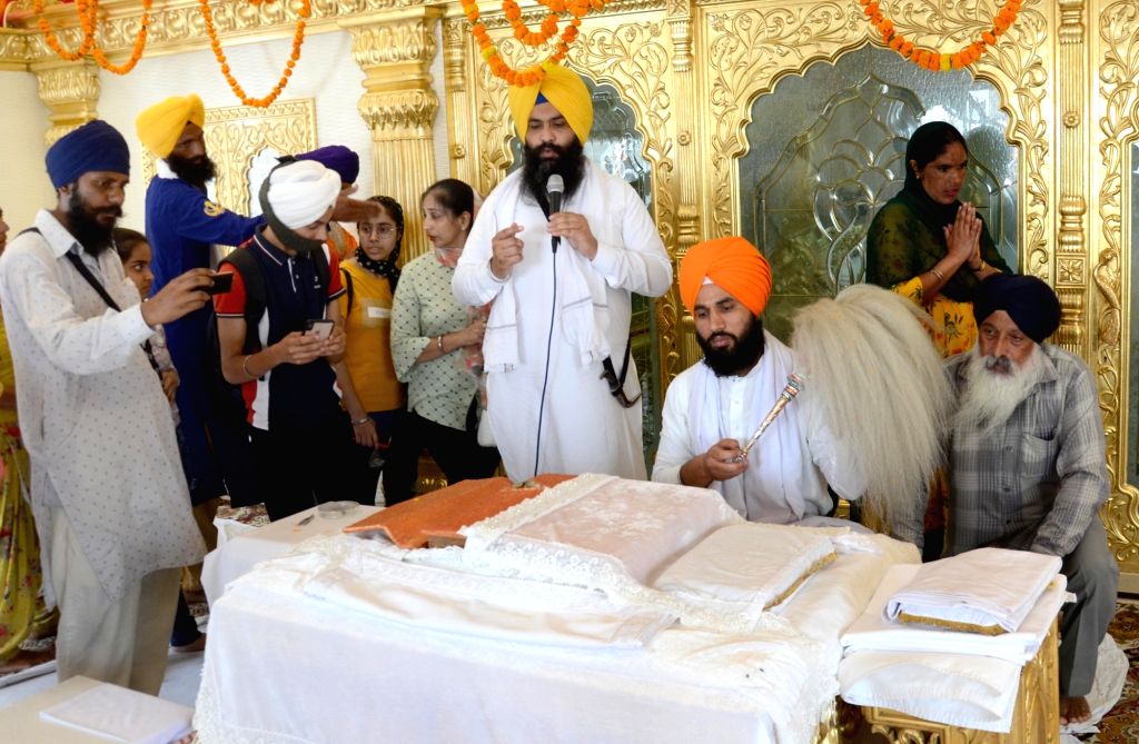Sikh priests display an edition of Sikh holy book Sri Guru Granth Sahib ...