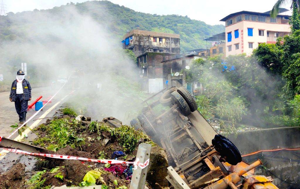 Smoke billows as a tanker carrying hazardous waste chemicals overturns