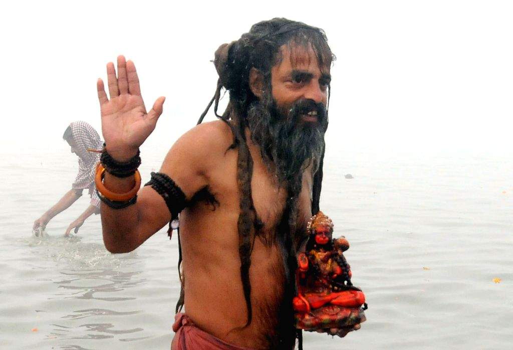 South 24 Parganas: A 'sadhu' takes a holy bath at the Sagar Island on ...