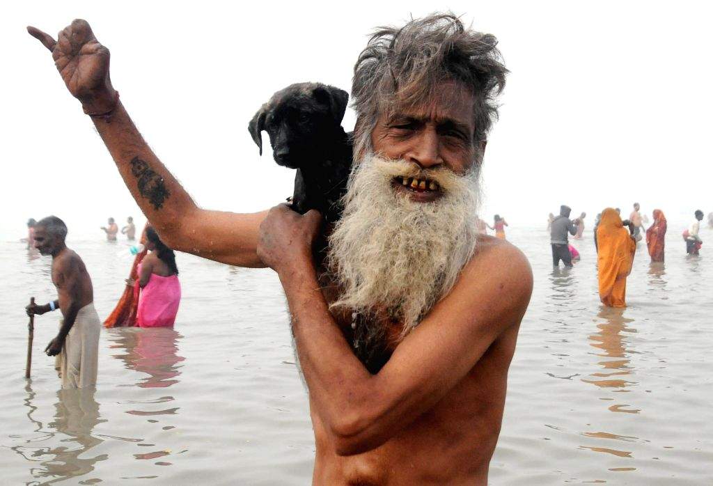 South 24 Parganas: A 'sadhu' takes a holy bath at the Sagar Island on ...