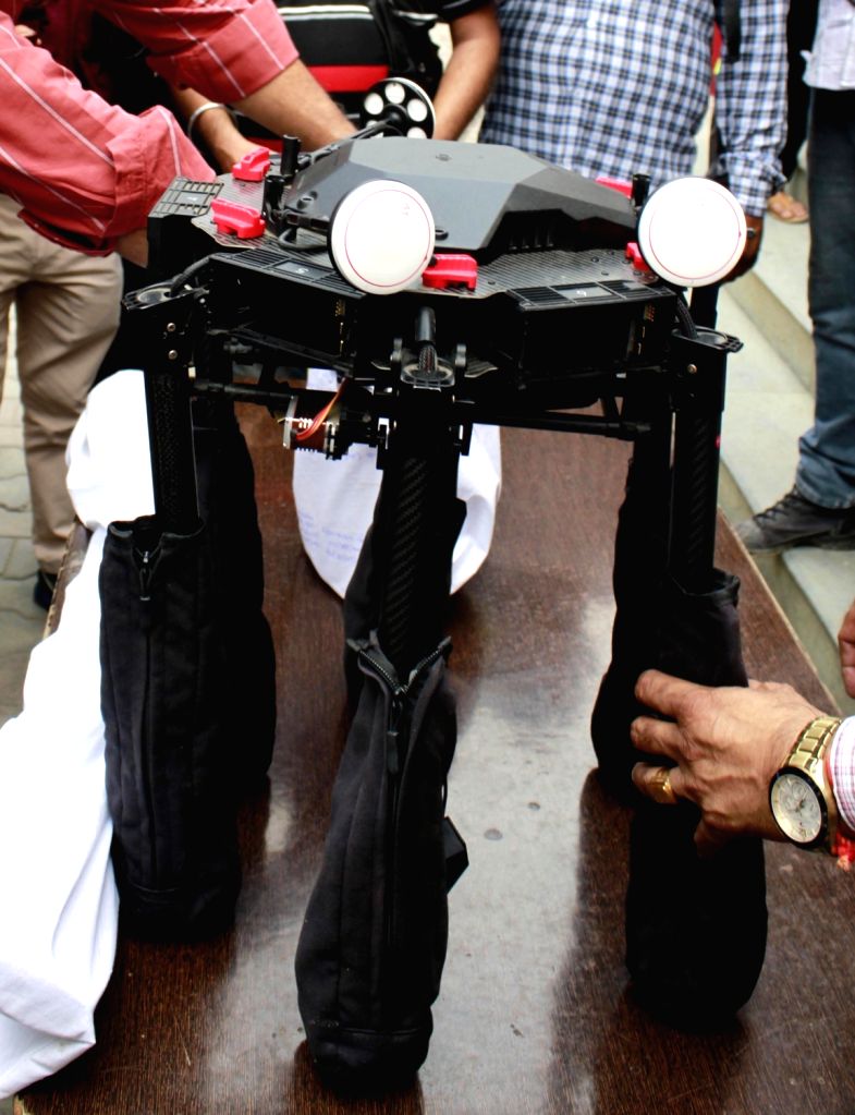Special Task Force (STF) personnel display the recovered drone and arms ...