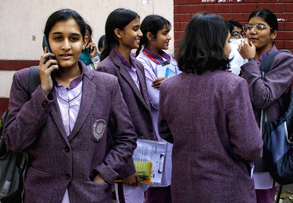 Students are seen discussing after appearing in the 10th and 12th CBSE ...