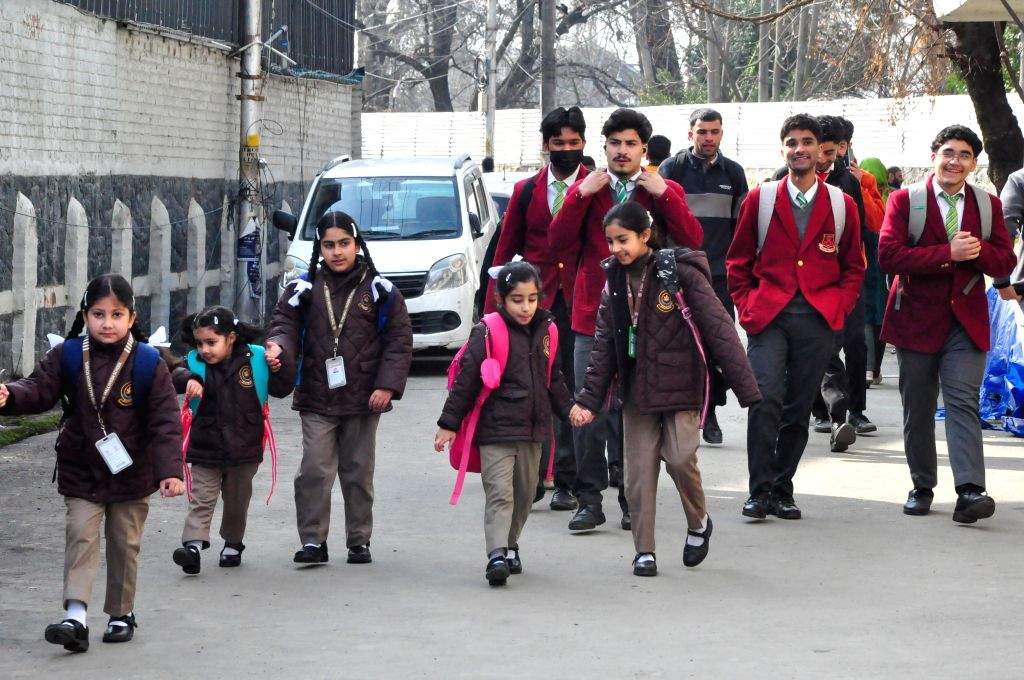 Students arrive at school to attend the first day of classes after a ...