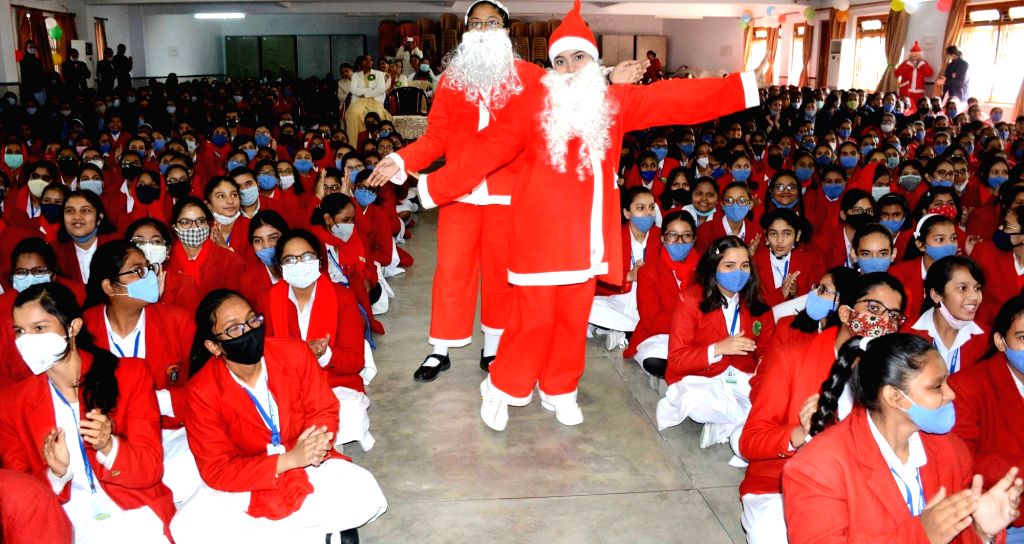Students from Carmel High School dressed as Santa Claus as they perform ...
