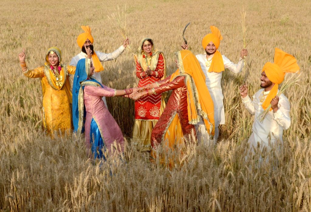 Students in traditional Punjabi attire perform a folk dance.