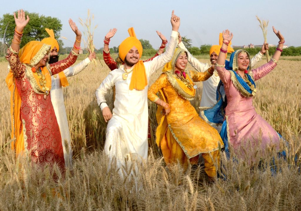 Students in traditional Punjabi attire perform a folk dance.