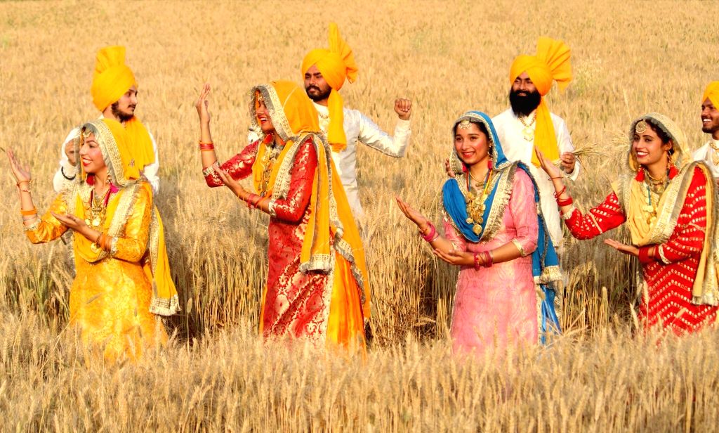 Students in traditional Punjabi attire perform a folk dance.