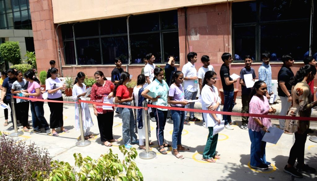 New Delhi : Students wait in a queue to appear in Common University ...