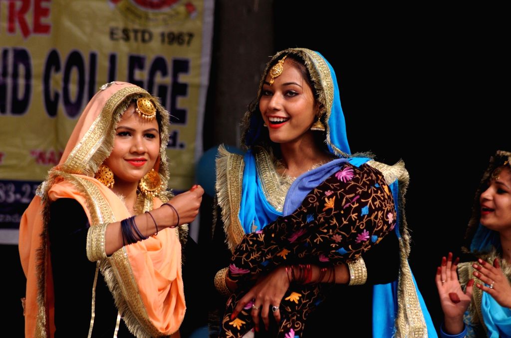 Students wearing traditional Punjabi attire, perform 'Gidha' during an ...