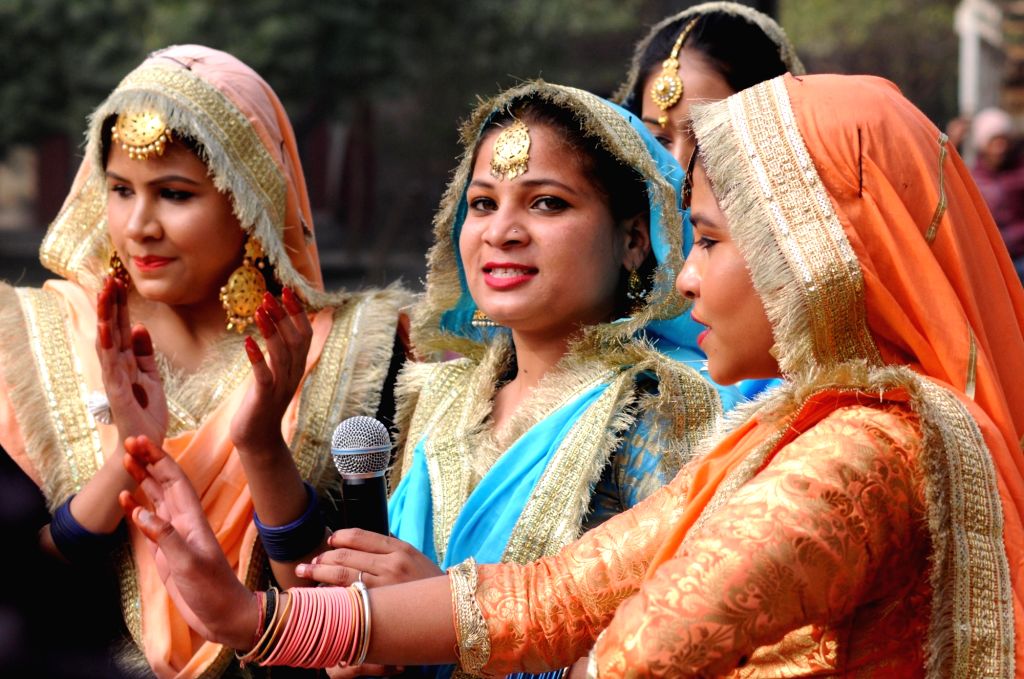 Students wearing traditional Punjabi attire, perform 'Gidha' during an ...