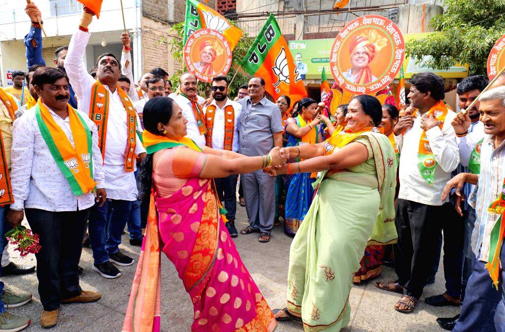 Supporters of BJP leader Devendra Fadnavis celebrate after he was ...