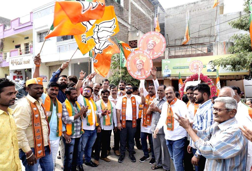 Supporters of BJP leader Devendra Fadnavis celebrate after he was ...