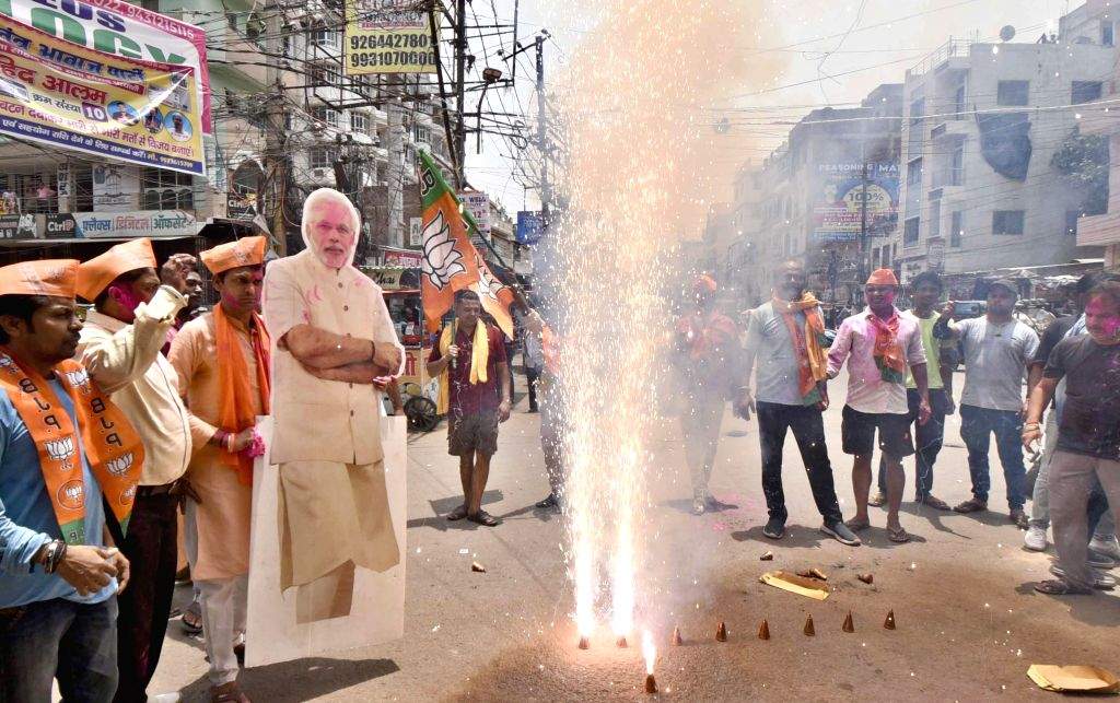 Supporters of PM-designate Narendra Modi celebrate ahead of his ...