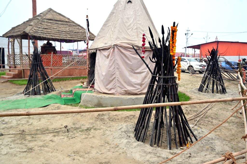 Traditional weapons and ceremonial setups on display at a camp