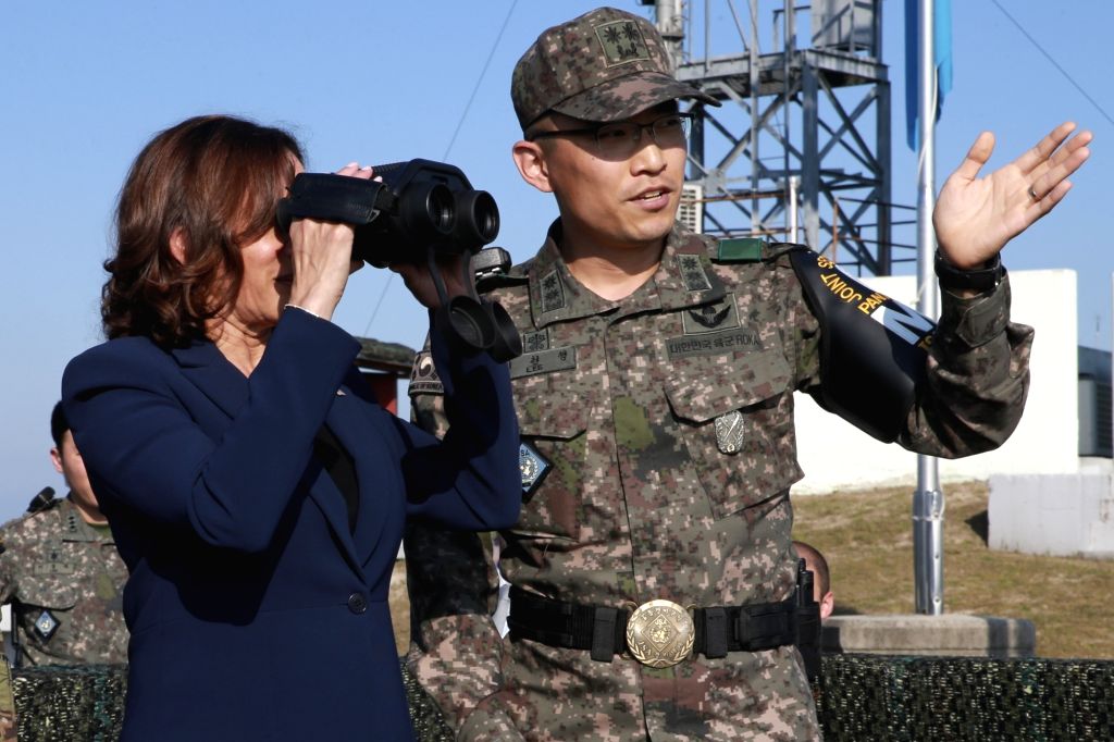 :Paju:Kamala Harris (L) uses binoculars to look at North Korea from the ...