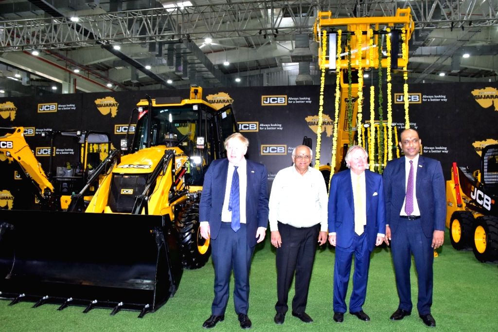 Free Photo: UK PM hops onto bulldozer at JCB plant in Gujarat.