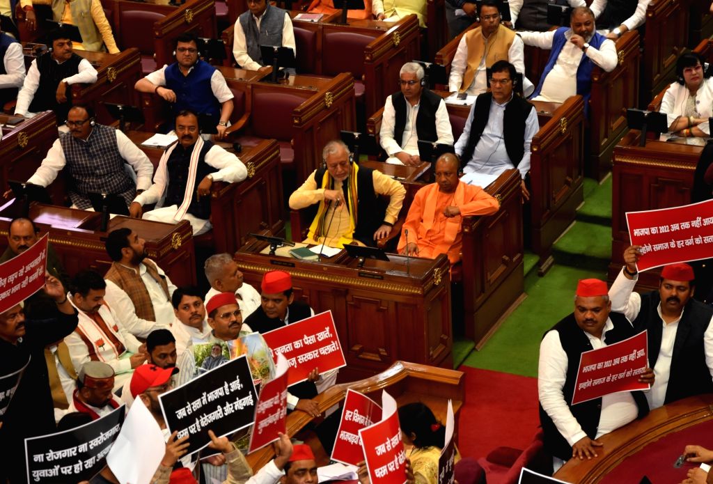 Uttar Pradesh CM Yogi Adityanath looks on as Samajwadi Party leaders ...