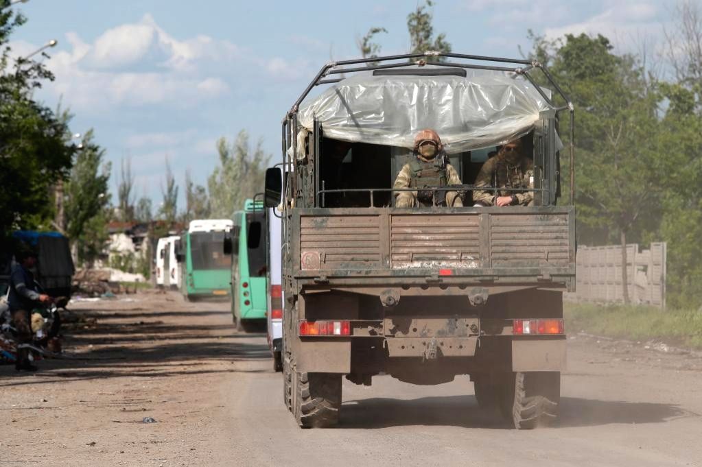 Vehicles carrying service members of the Ukrainian armed forces leave ...