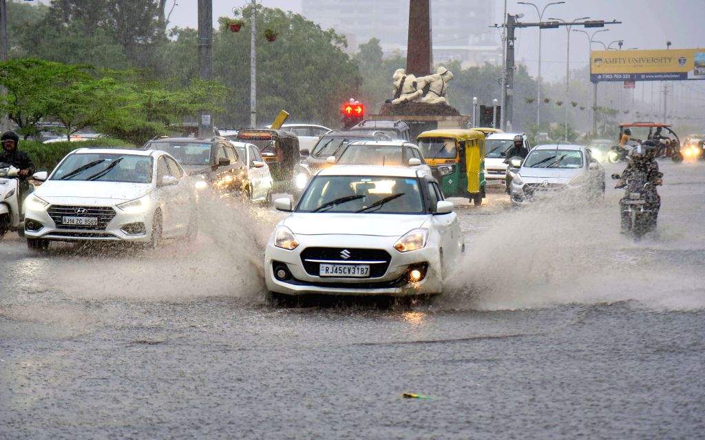 Vehicles navigate through waterlogged road as heavy rain lashes in Jaipur