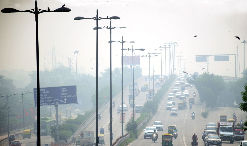 Vehicles ply on road amid heavy smog condition