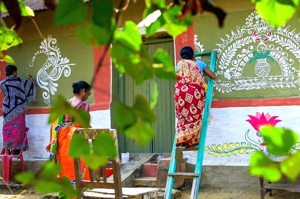 Villagers of Lankamura create wall paintings and alpona on mud walls