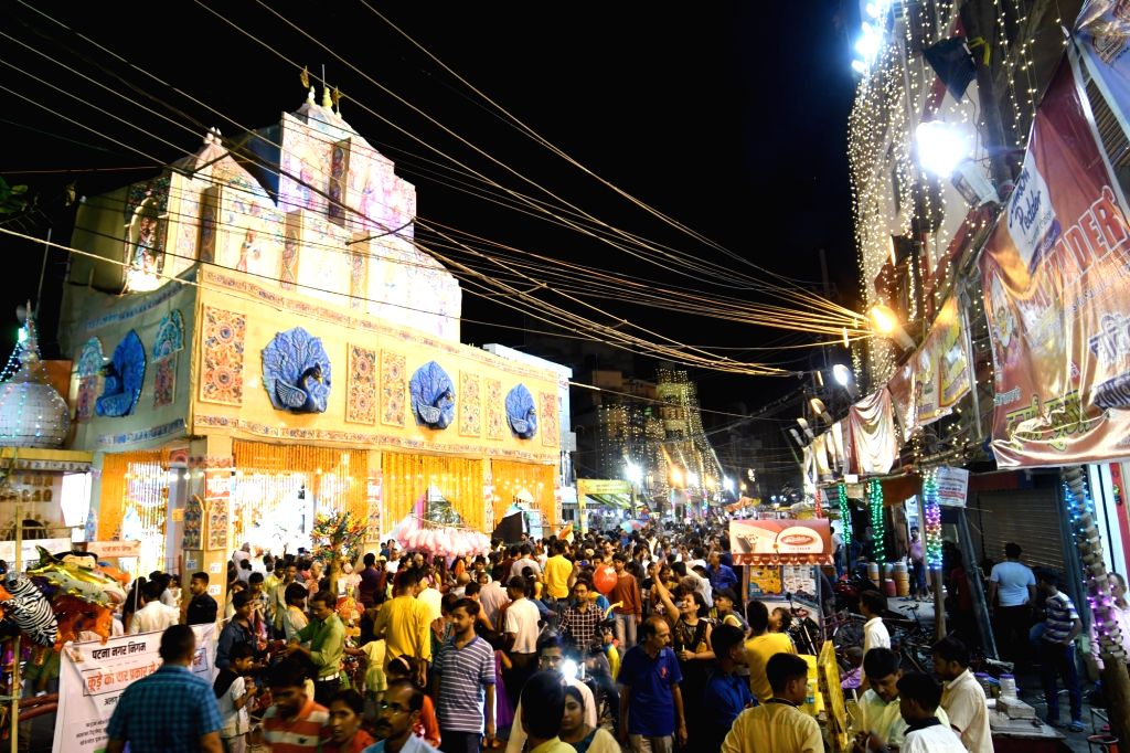 Visitors crowd at a puja pandal on the ninth day of Durga Puja festival