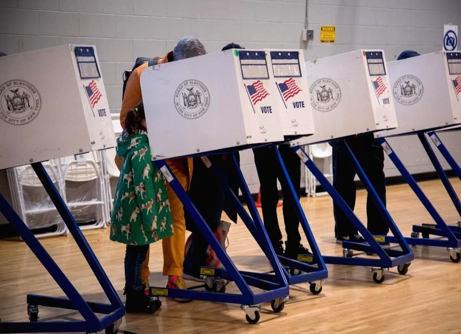 New York :Voters fill in their ballots at a polling station in New York