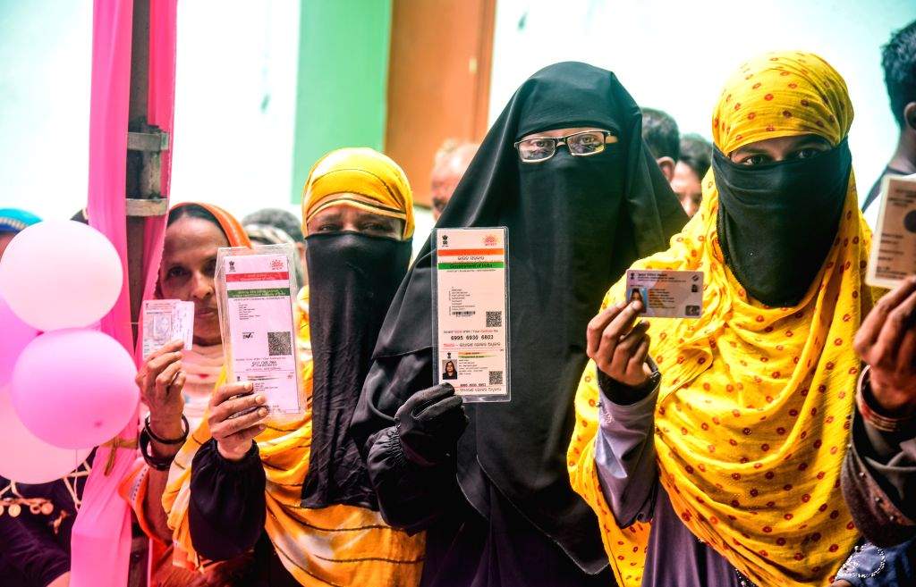 Voters standing in queue to cast their votes at a polling booth during ...