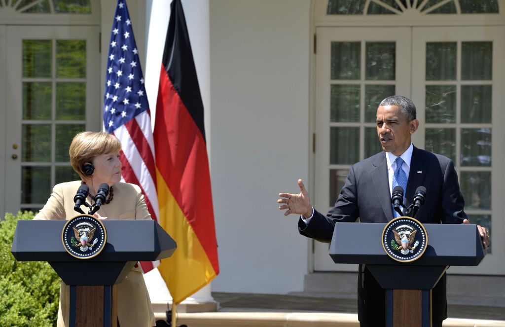 U.S. President Barack Obama walks with with German Chancellor Angela ...