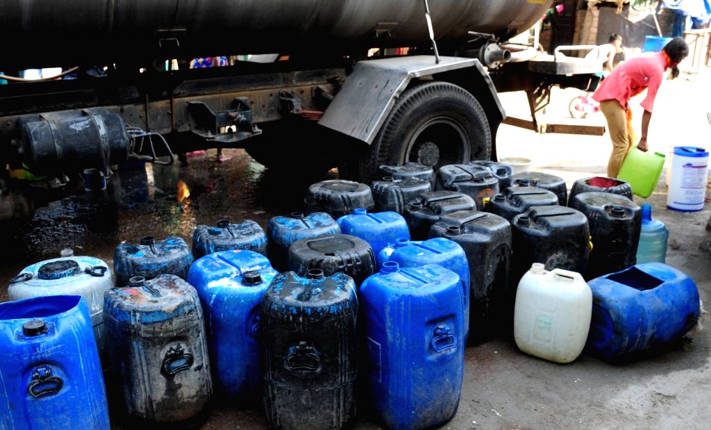 Water-filled containers kept aside after filling it from a water tanker ...