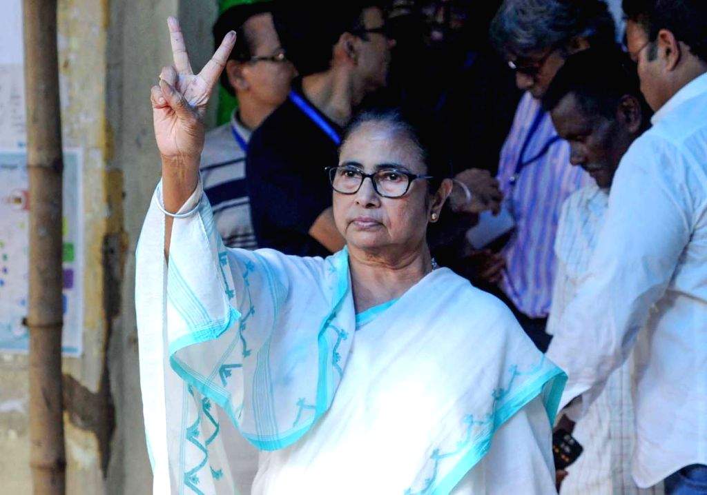 West Bengal Chief Minister Mamata Banerjee flashes a victory sign after ...