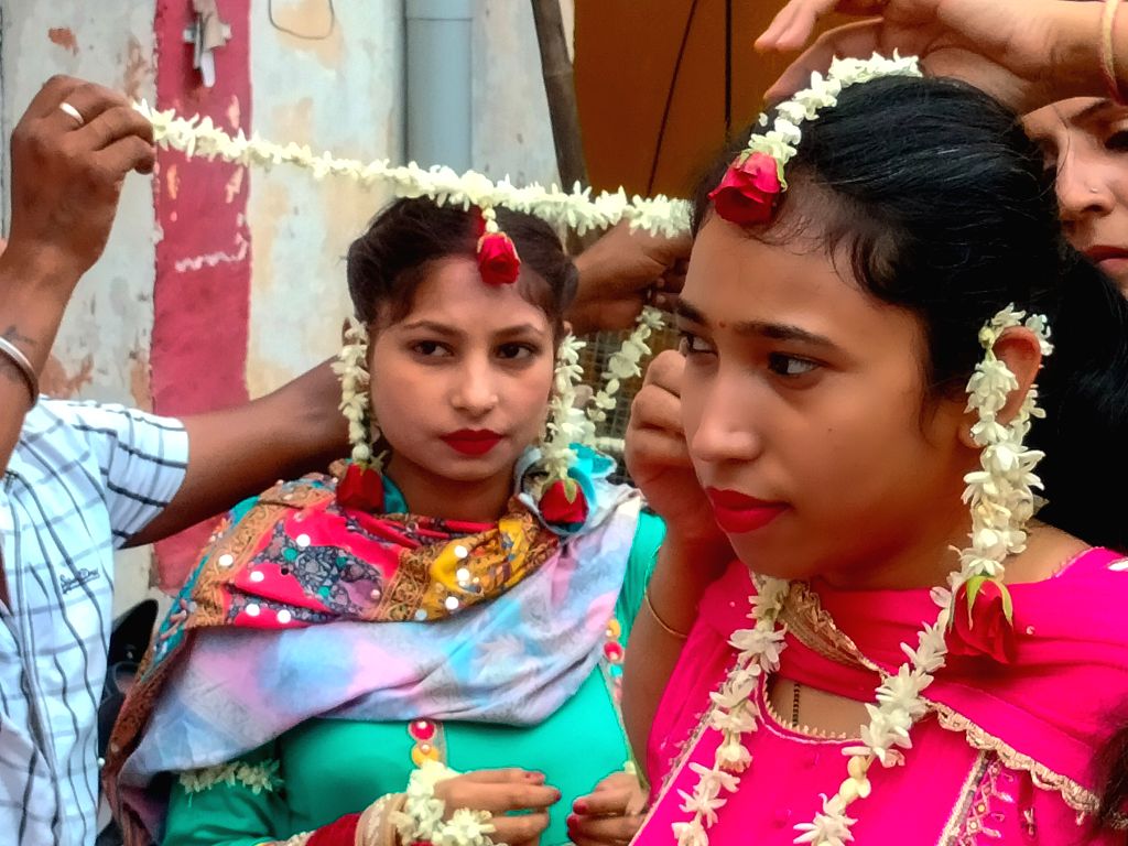 Women adorned with flowers during Teej festival during celebrations to ...