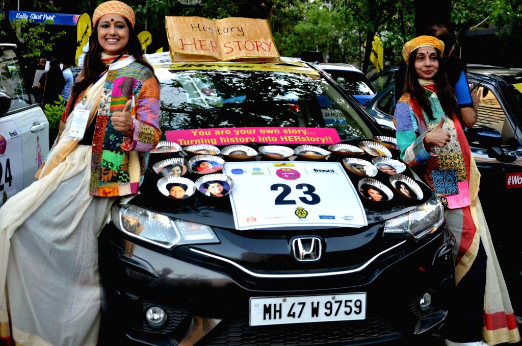 :Mumbai:women pose with the car during an event to promote more women ...