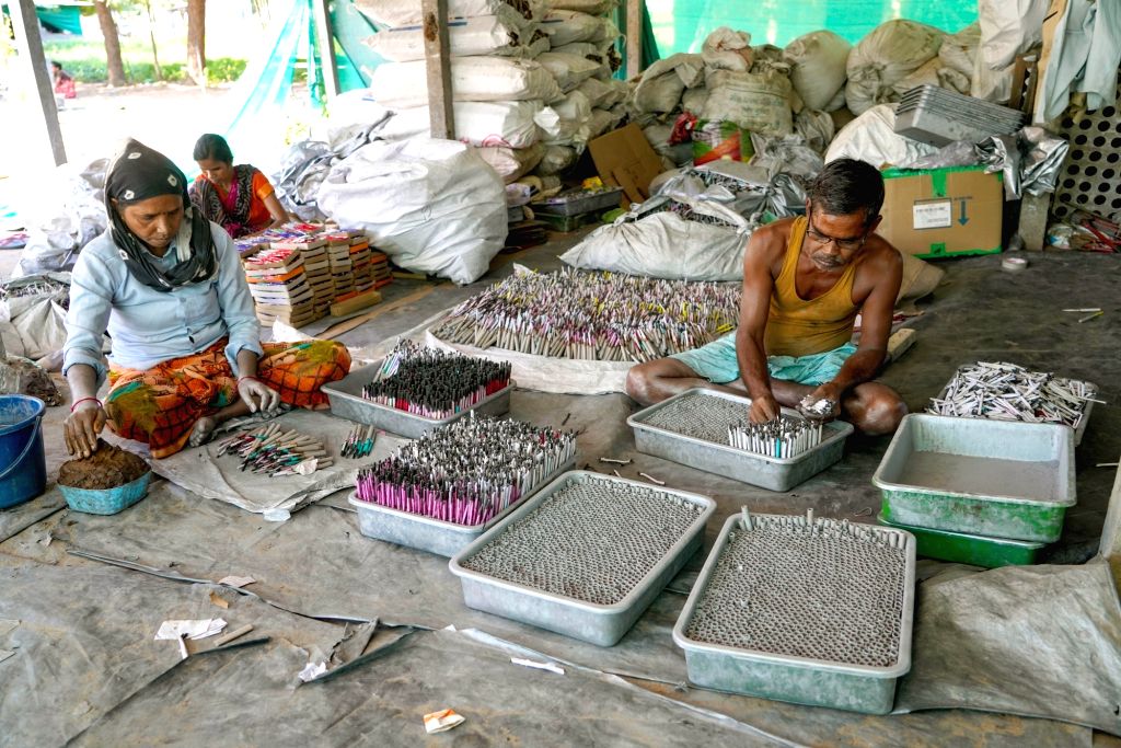 : Ahmedabad: Workers make firecrackers for the upcoming Diwali festival