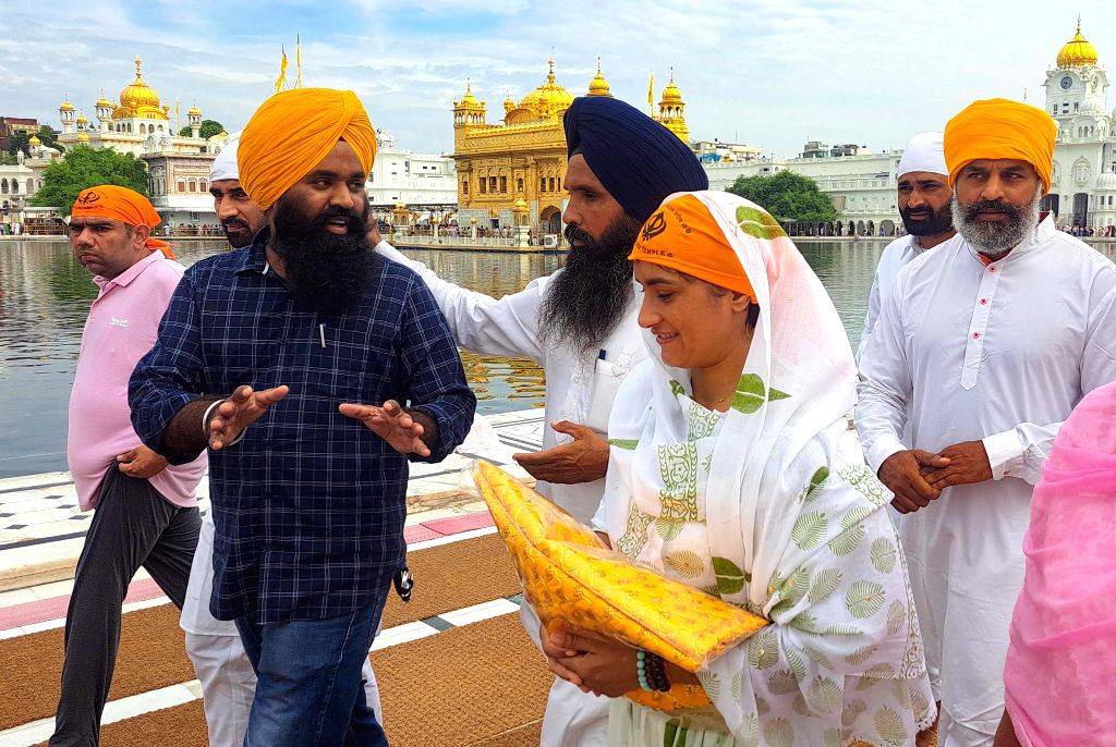 Wrestler Vinesh Phogat with family visits and offer prayer at Golden Temple