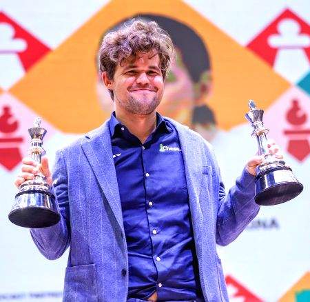 Norwegian chess grandmaster Magnus Carlsen poses with his trophy after ...