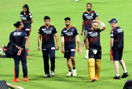 RCB players with support staff during a practice session