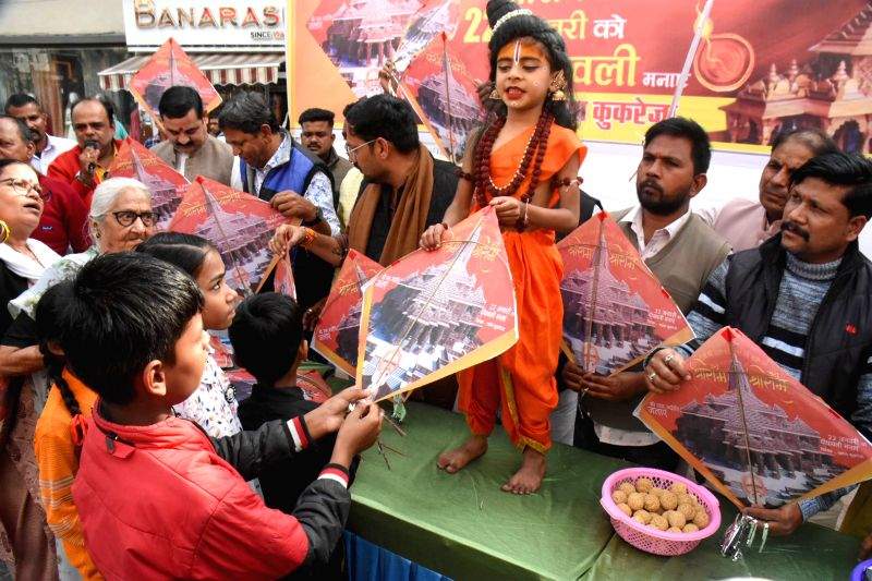A child dressed as Lord Ram show kites depicting pictures of Ayodhya's ...