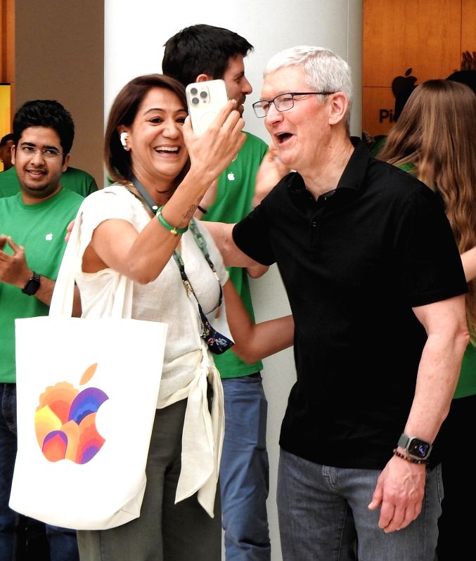 New Delhi : Apple CEO Tim Cook poses for a selfie with a customer at ...