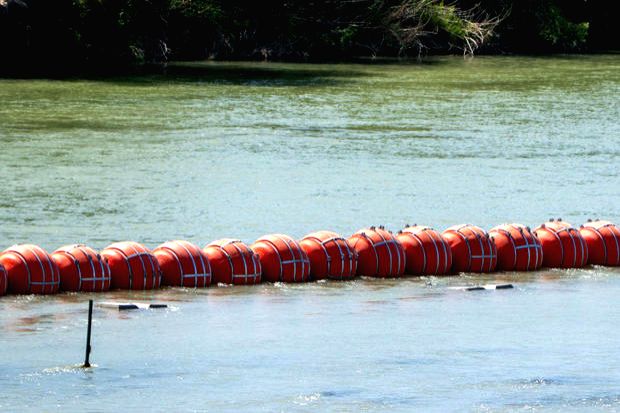 Biden admin sues Texas over water barriers to block migrants crossing ...